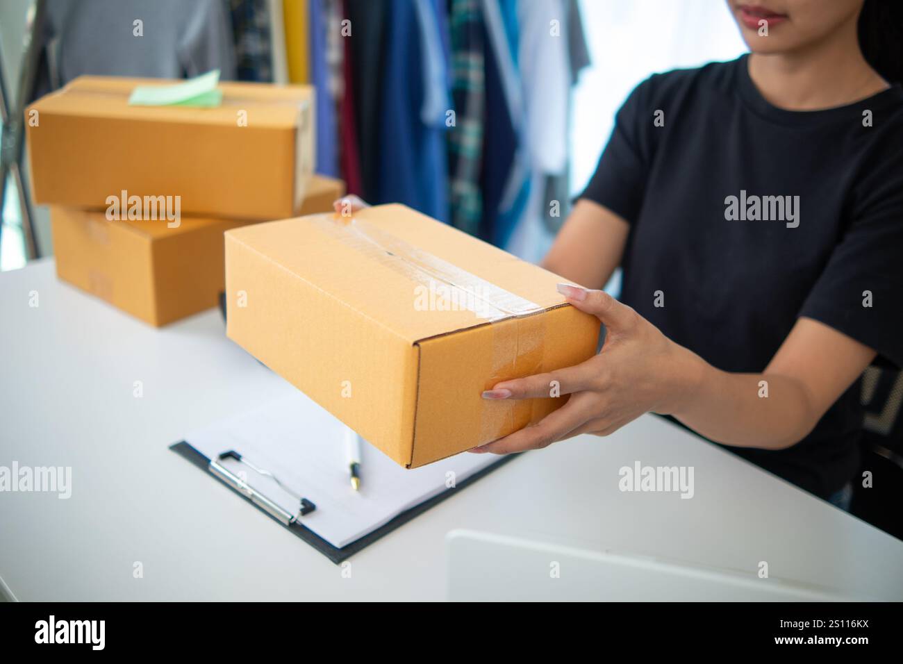 Start Up entrepreneurs who are running SME businesses are preparing products in boxes and ...