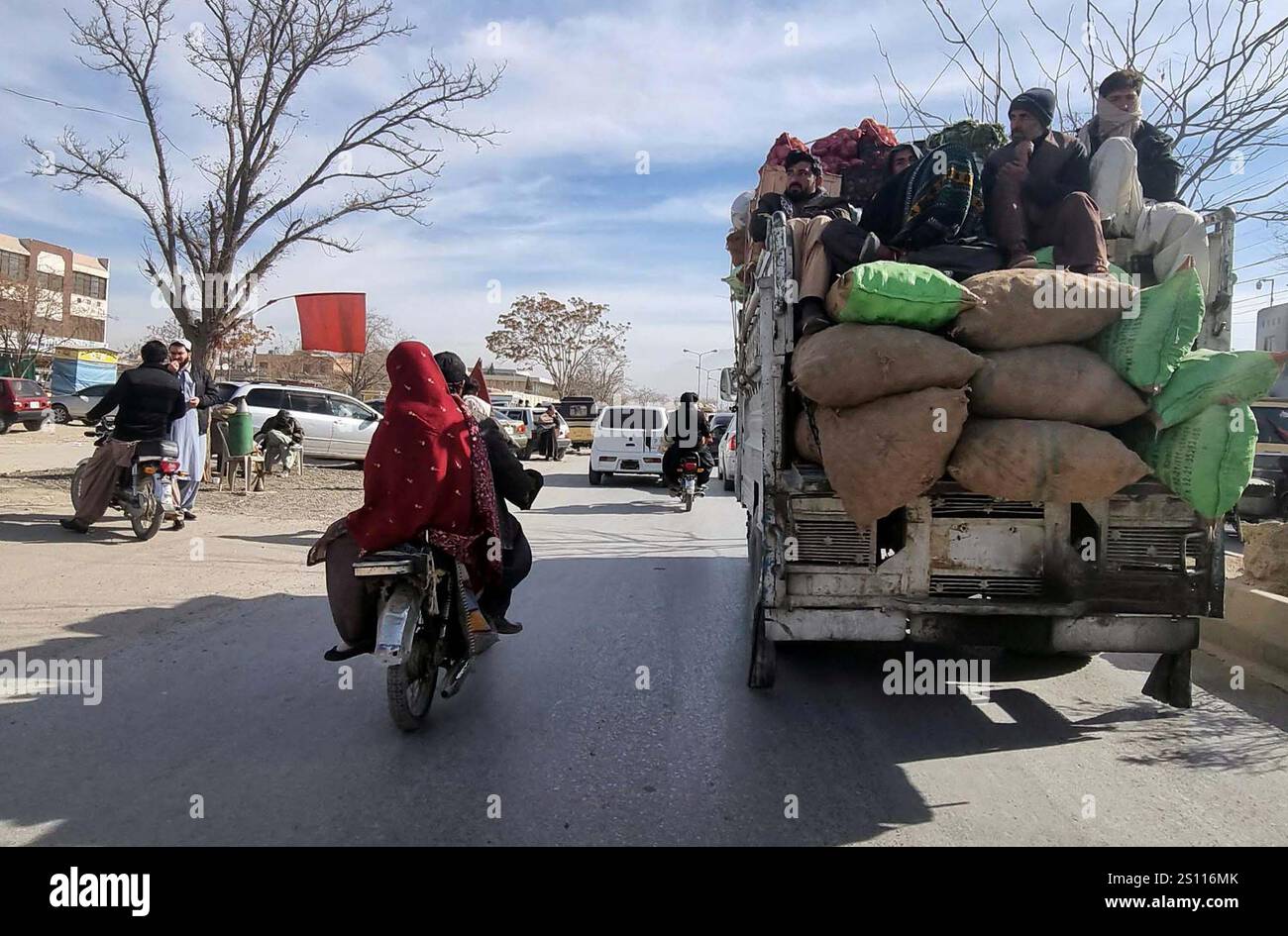 An overloaded vehicle carry huge vegetables passing through the road ...