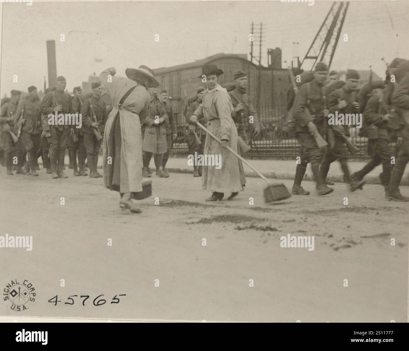 English women cleaning streets. U.S. soldiers marching by. Main Dock ...
