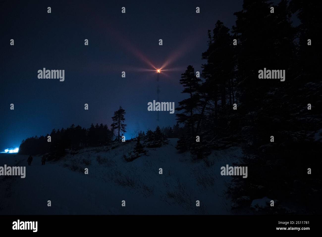 Lighthouse Lit Up in Orange Color in the Forest at Night in Winter at ...