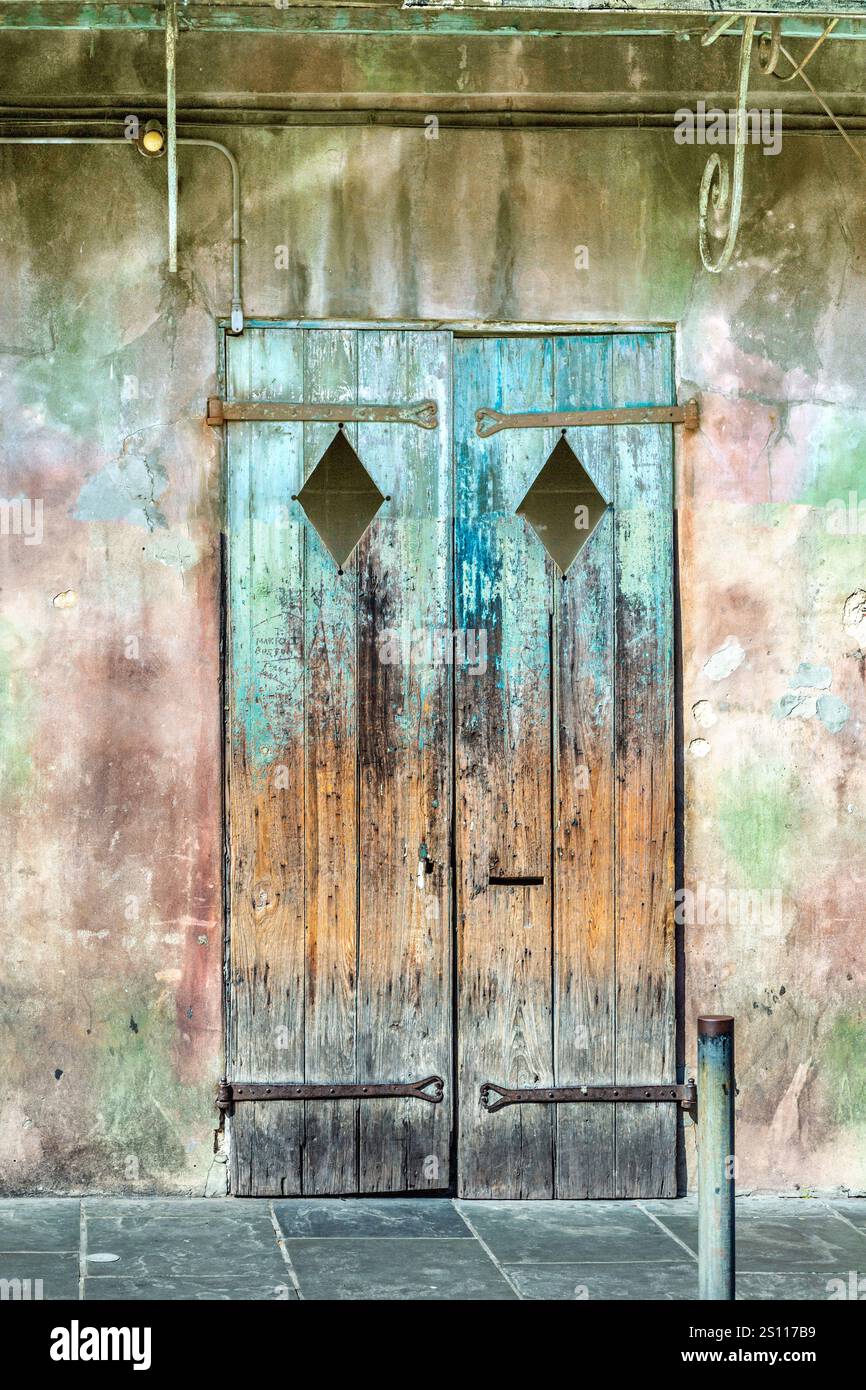old rotten wooden doors with peeling color in the historic district of ...
