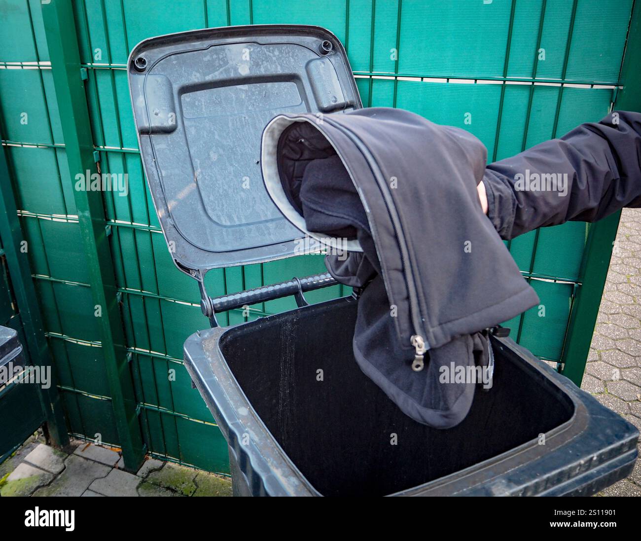 Germany. Disposal of clothing in the normal household waste garbage can ...
