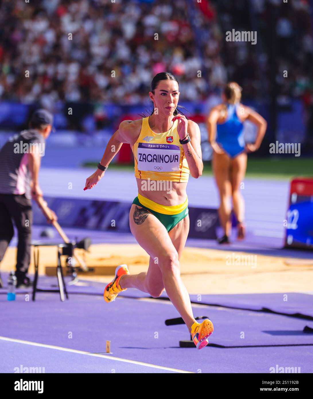 Diana Zagainova celebrating her medal with her country's flag at the ...