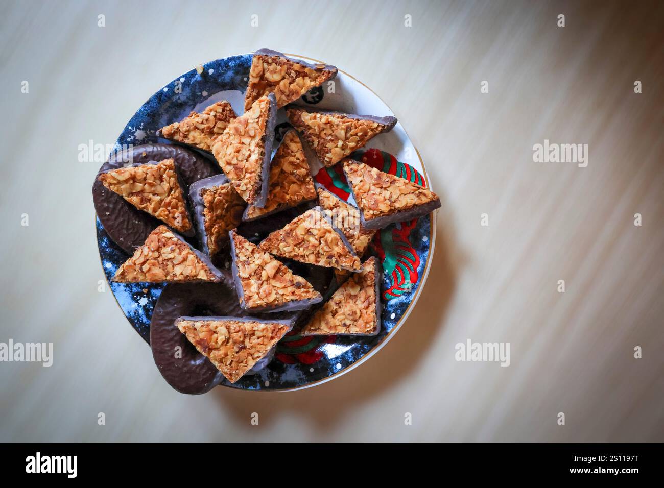Christmas snacks nut triangles on a plate from above isolated with text ...
