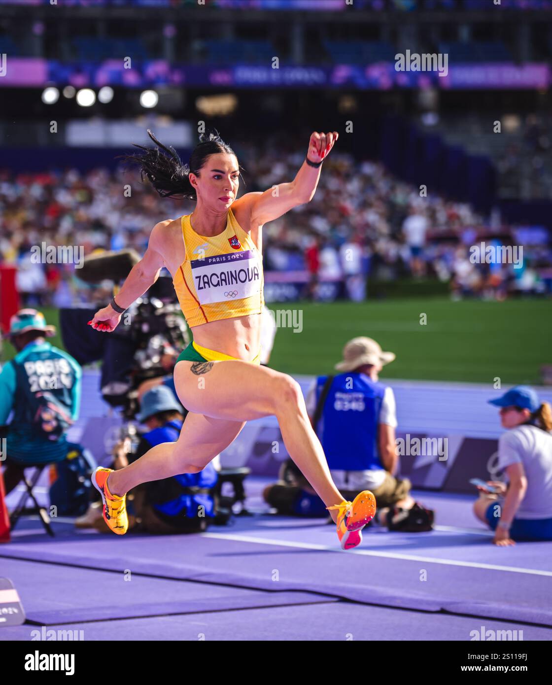 Diana Zagainova celebrating her medal with her country's flag at the ...