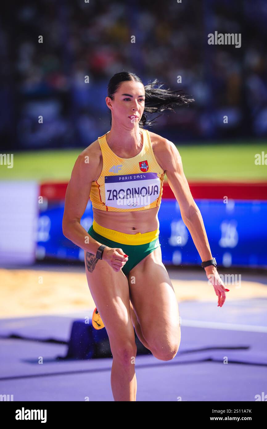Diana Zagainova celebrating her medal with her country's flag at the ...