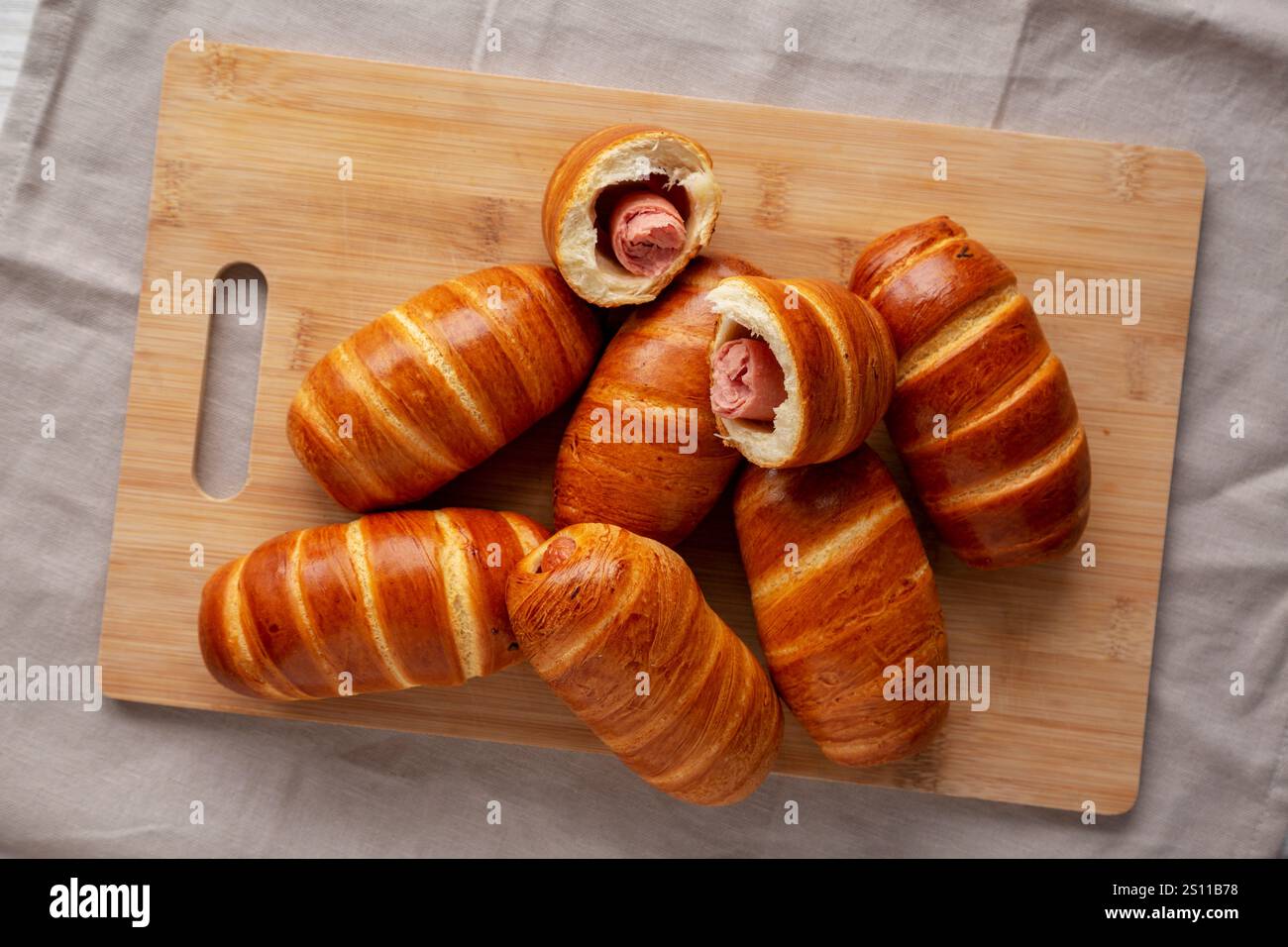 Homemade Sausage Buns on a bamboo board, top view. Flat lay, overhead ...