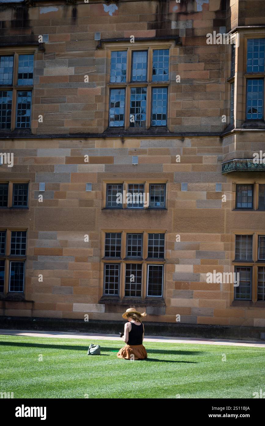 Woman sitting on grass, The University of Sydney Main Quadrangle, it ...