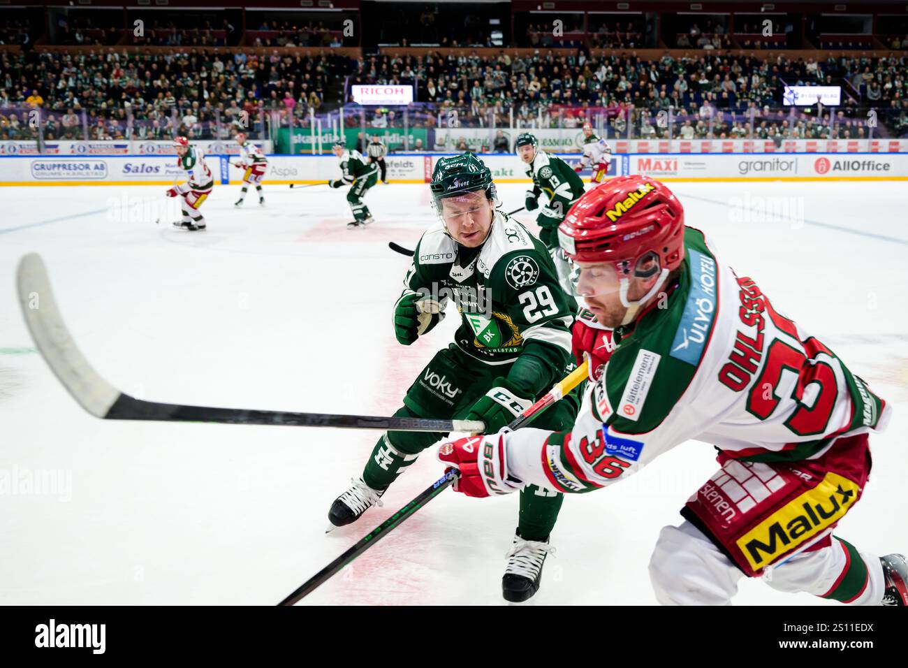 Karlstad, Sverige. 30th Dec, 2024. 241230 Färjestads Oskar Steen och Modos Sebastian Ohlsson ...
