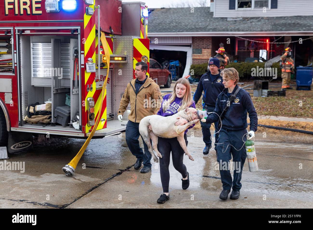 Ariel Westcott carries her mother's dog, Karma, while Mika Richards ...