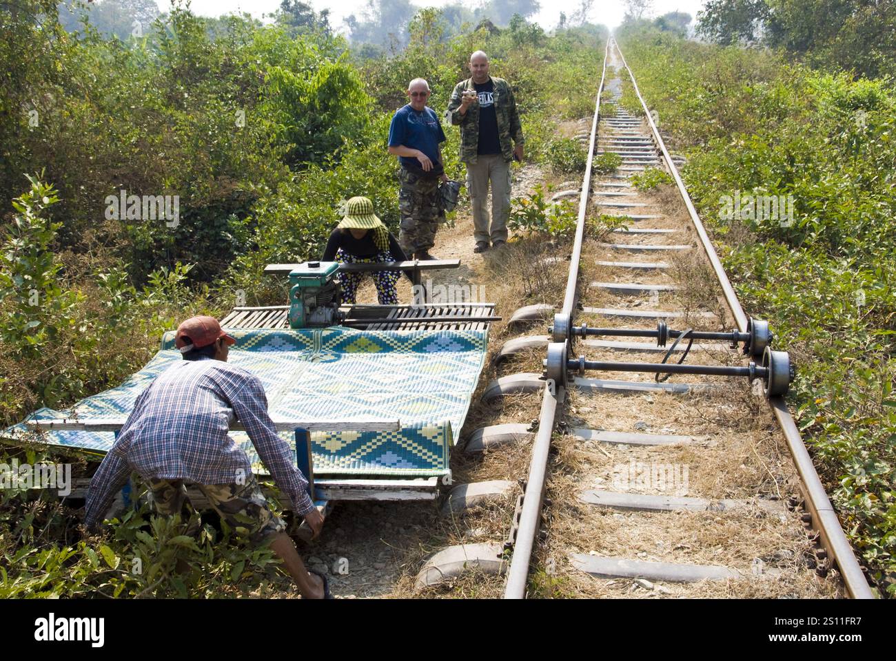 Drivers lift a homemade rail car onto tracks. Battambang's Bamboo Train ...
