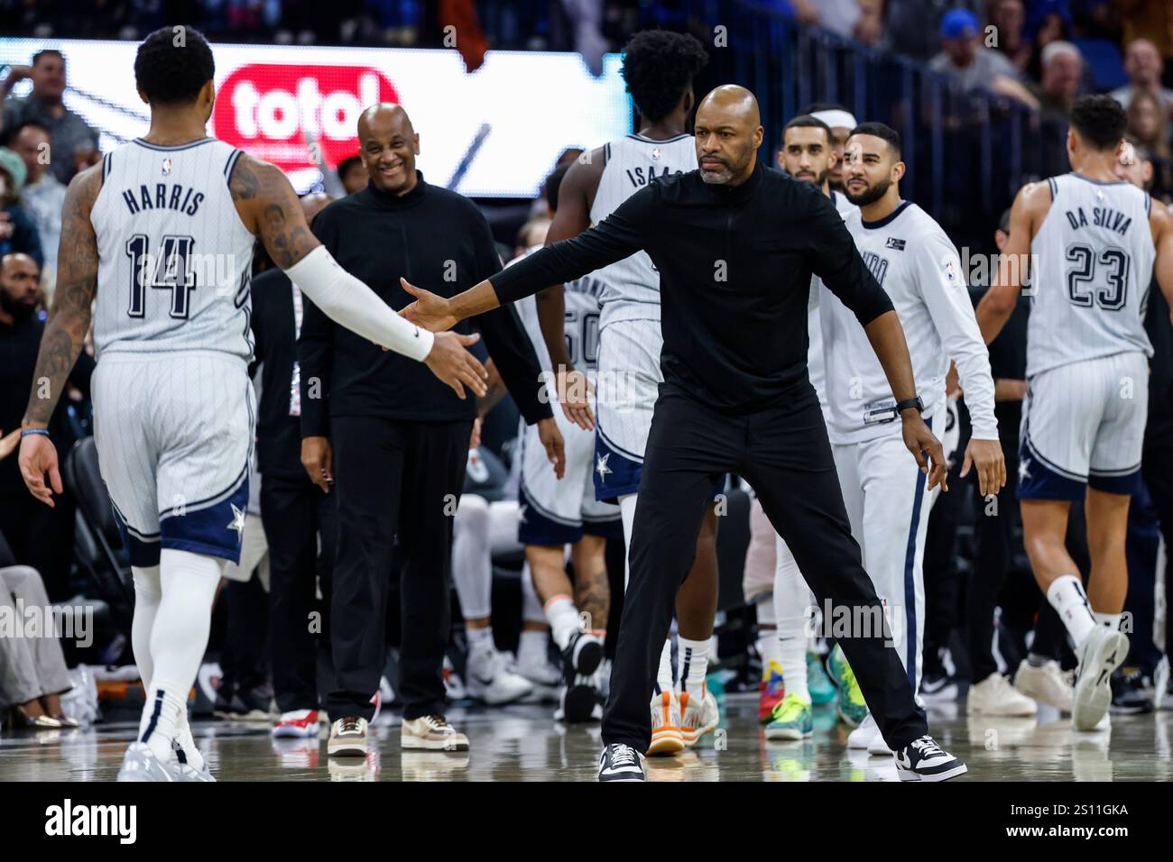 Orlando Magic head coach Jamahl Mosley congratulates guard Gary Harris ...