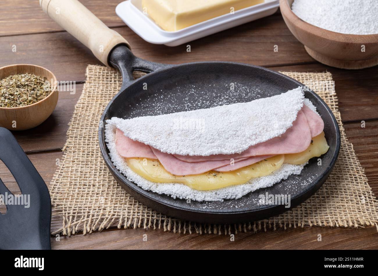 Traditional brazilian cheese and ham stuffed tapioca on a pan with ...