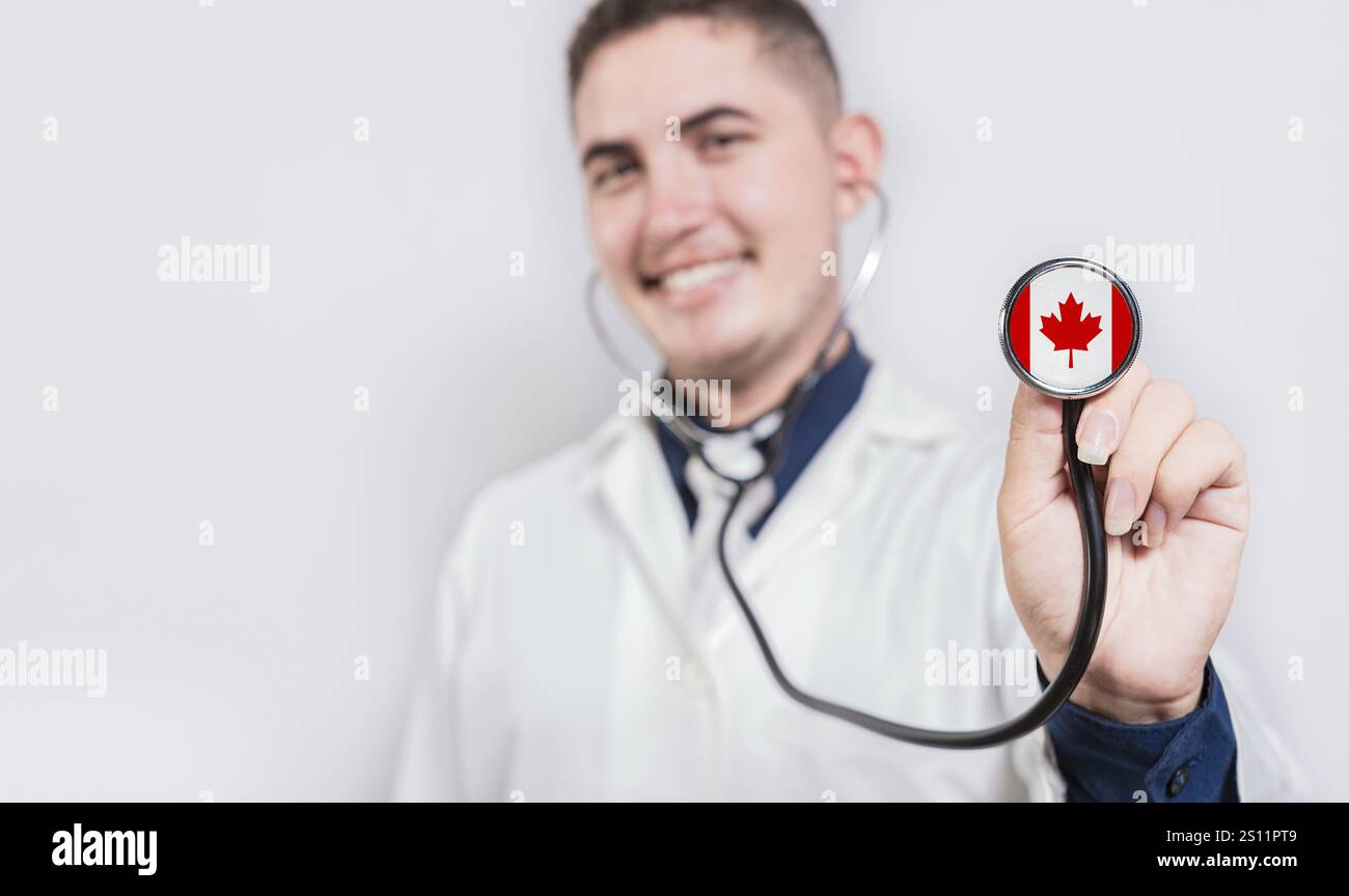 Smiling doctor showing stethoscope with Canada flag. Canada National ...