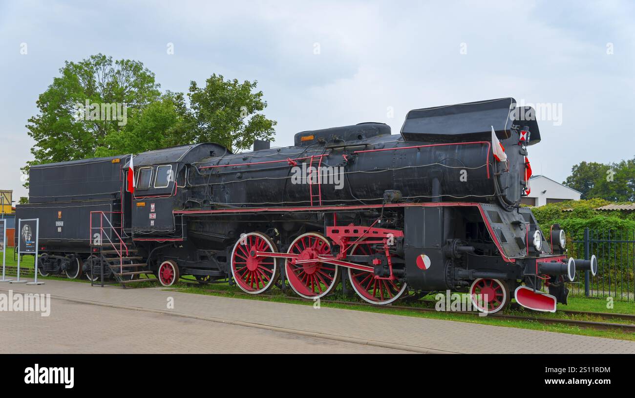 Historic black steam locomotive with red wheels on a platform, Polish ...