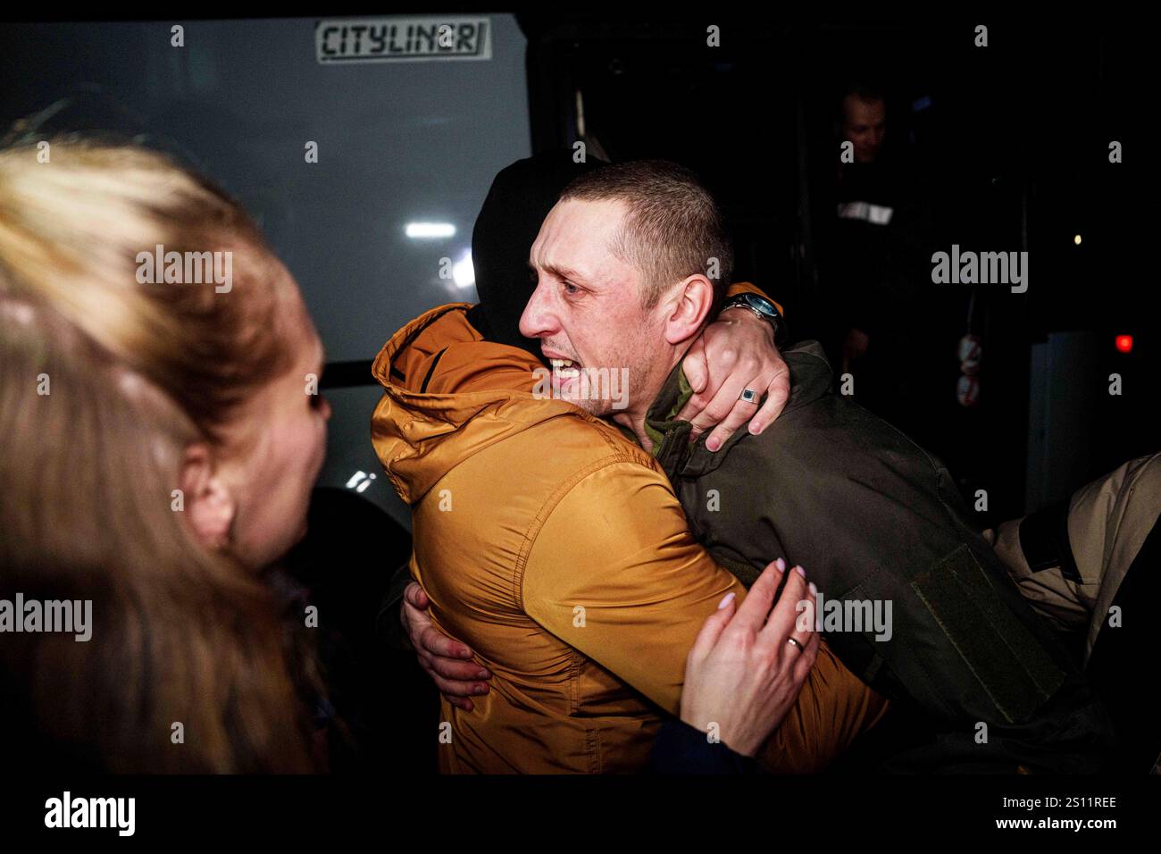 A Ukrainian serviceman hugs a relative after returning from captivity ...