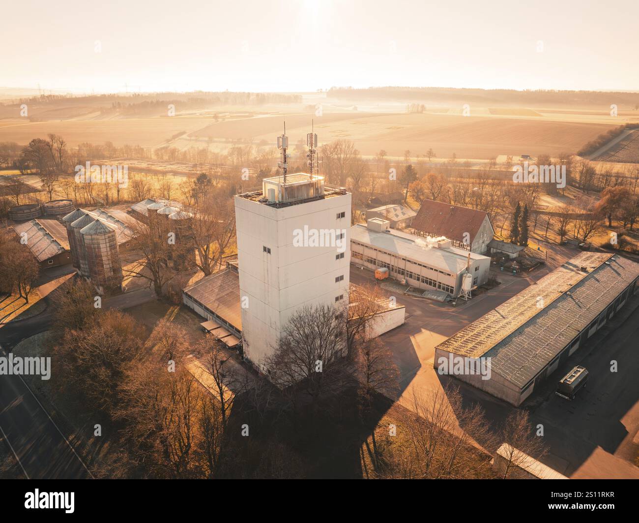 Industrial complex in a rural setting in the sunshine, surrounded by ...