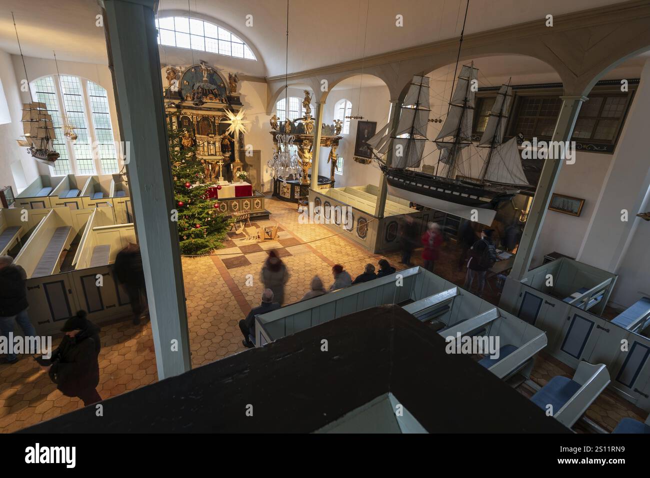Church interior with model ships and festive Christmas tree, surrounded ...