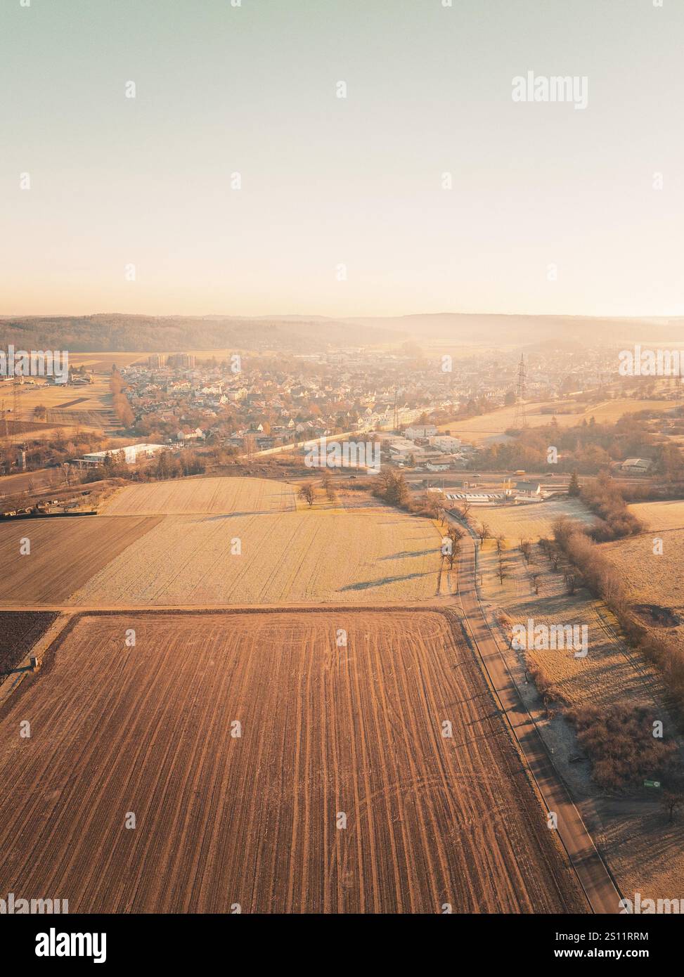 Wide fields and a village in the morning from a bird's eye view ...