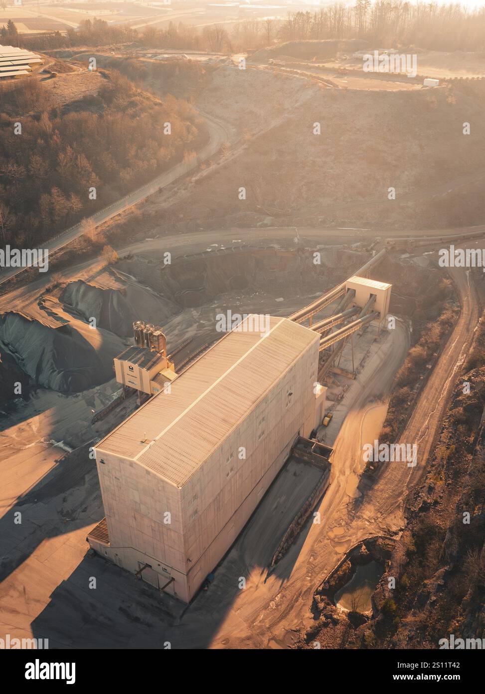 Bird's eye view of industrial buildings in the quarry at sunset ...
