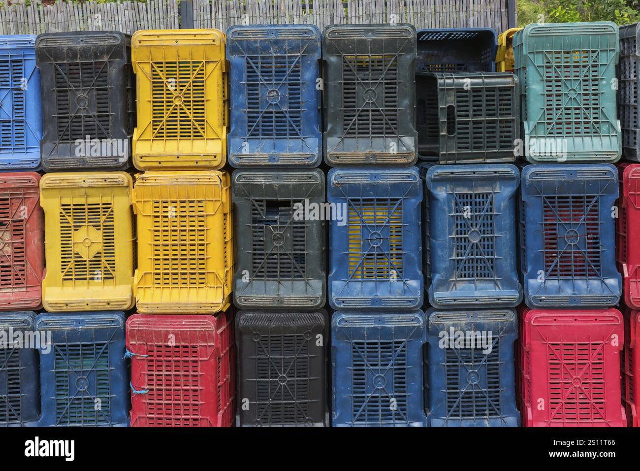 Rows of stacked colourful heavy duty plastic crates for transporting ...