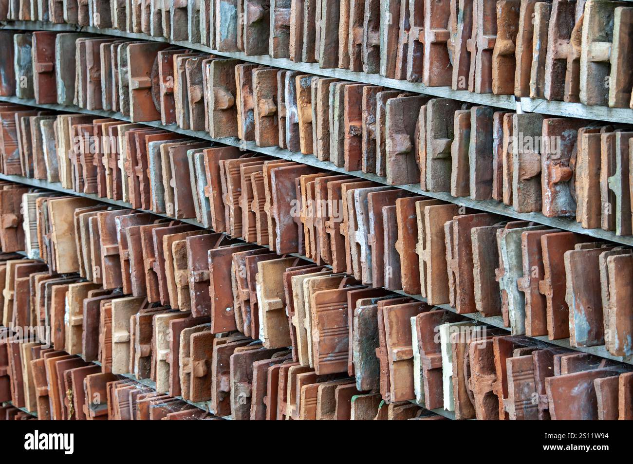 Rows of neatly arranged roof tiles form a visually appealing backdrop ...