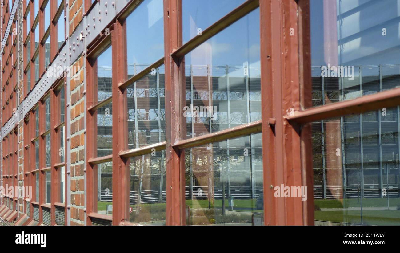 Red window frames reflecting a modern building on a bright sunny day ...