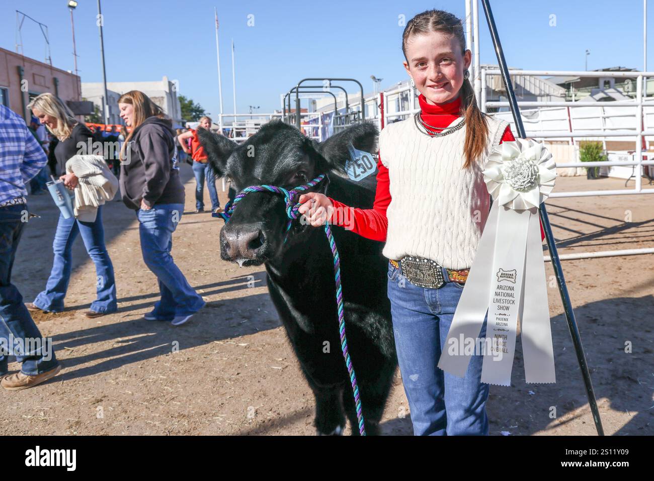 A winner of the Jr. Cattleman Showmanship proudly poses after exiting ...