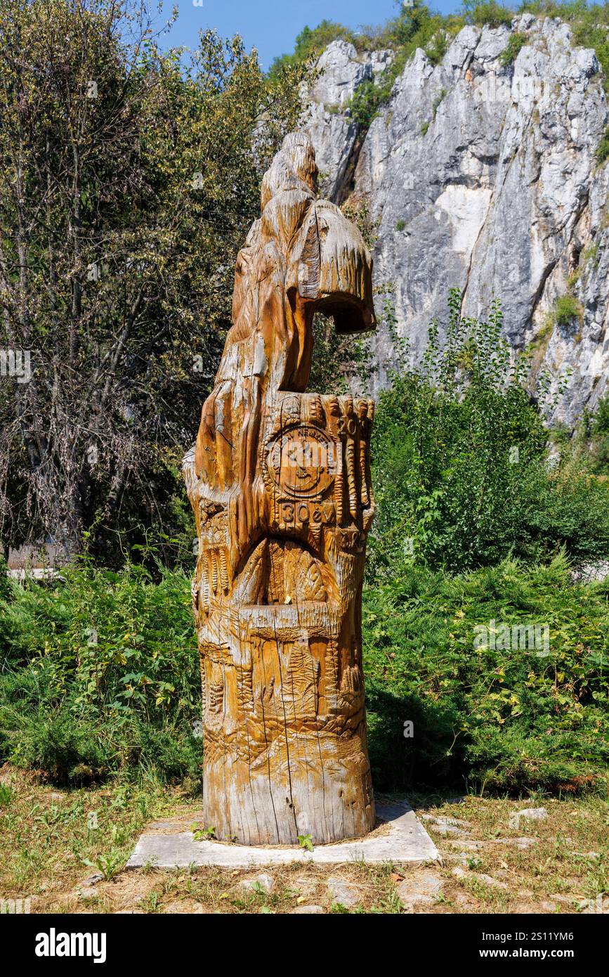 Carved statue with cave salamander, Jaskyna Domica, entrance to the ...