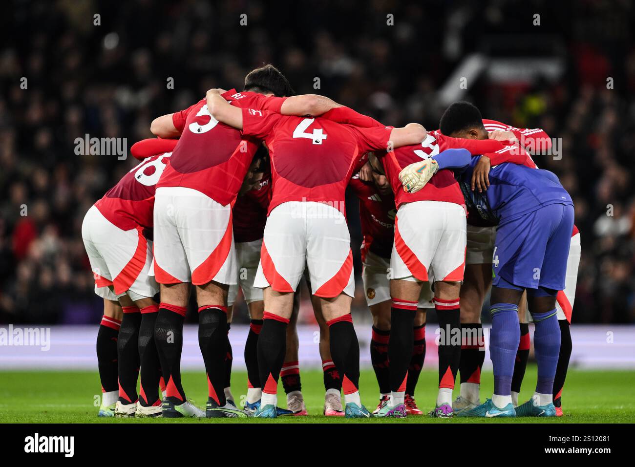 Manchester, UK. 30th Dec, 2024. Manchester United players form a huddle during the Premier ...