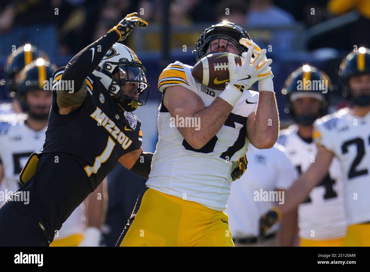 Iowa tight end Addison Ostrenga (87) makes a catch over Missouri safety ...
