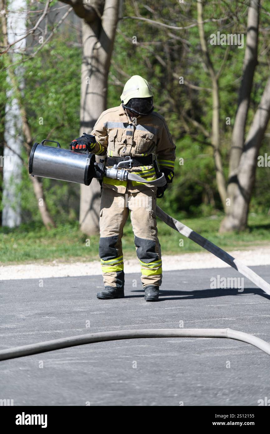 Firefighter Preparing To Use Foam Device Outdoors Stock Photo - Alamy