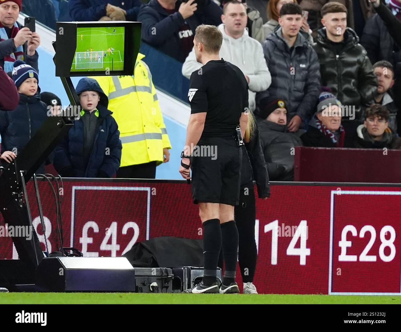 Referee Craig Pawson checks the VAR monitor during the Premier League ...