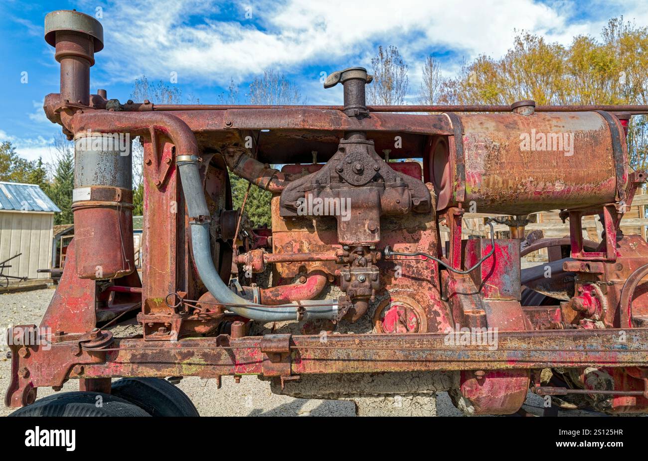 The rusty engine compartment of an antique tractor in the Nevada desert ...