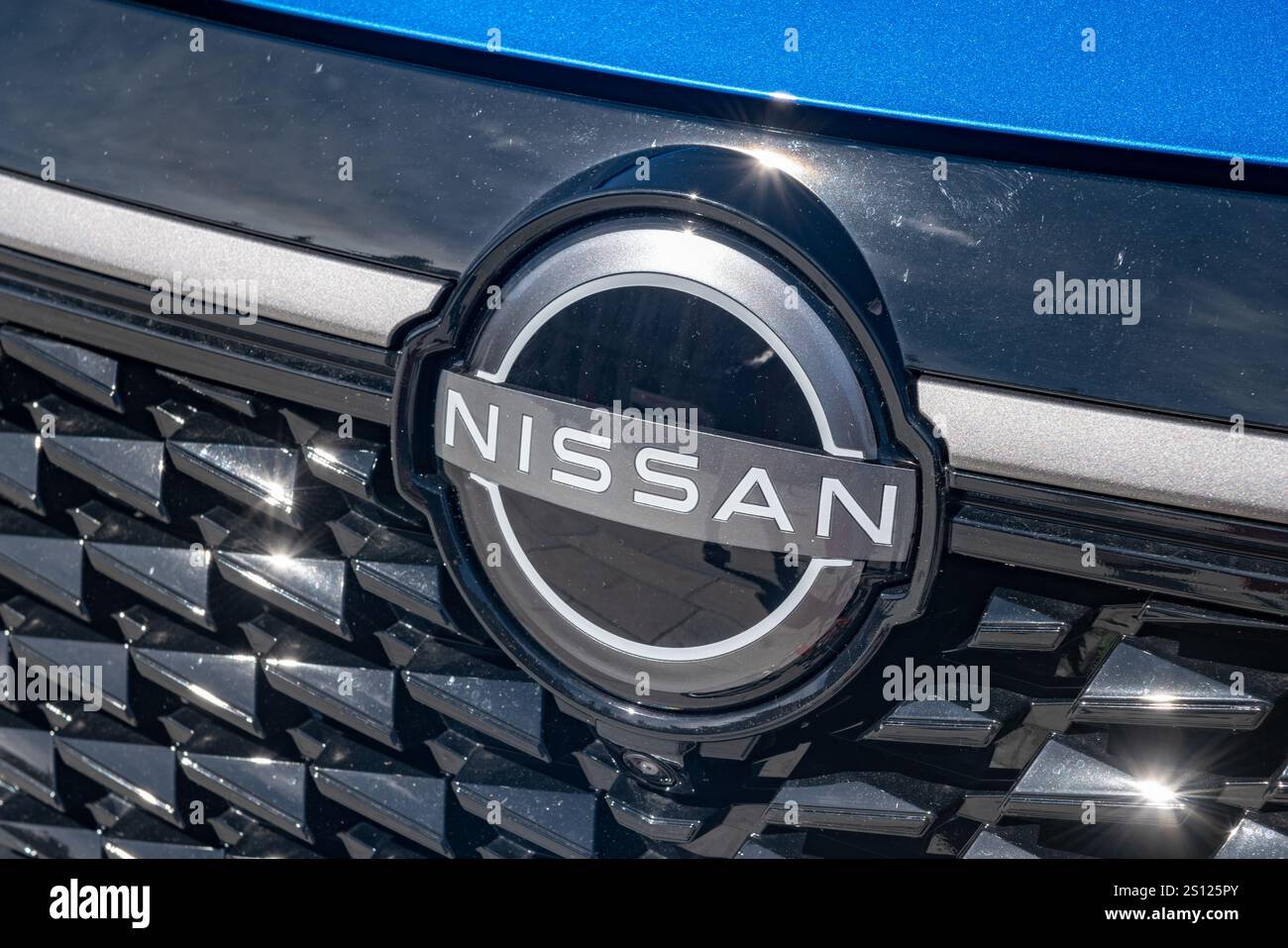 Nissan, logo with silver circle and powerful lettering, represents ...