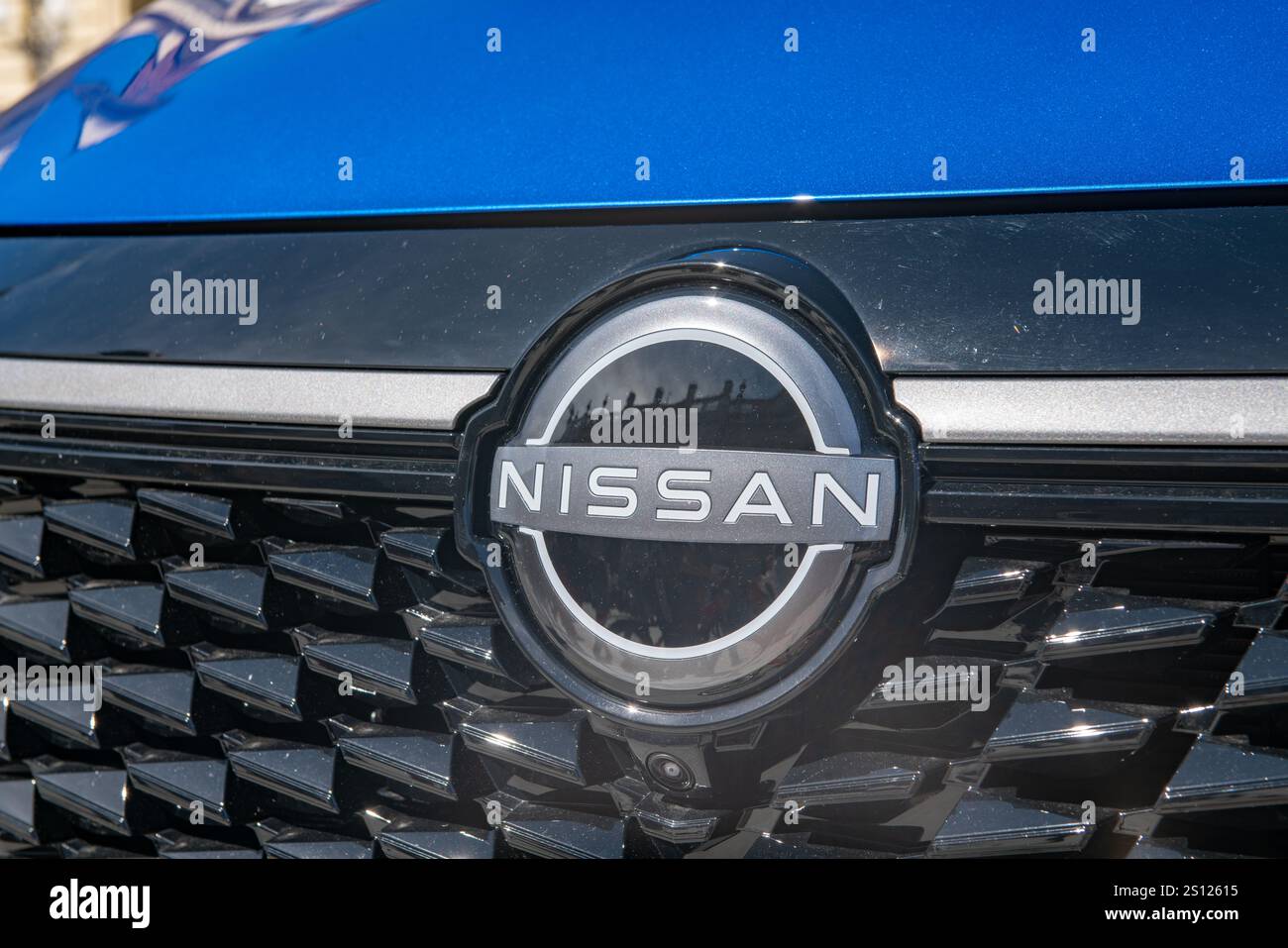 Nissan, logo with silver circle and powerful lettering, represents ...