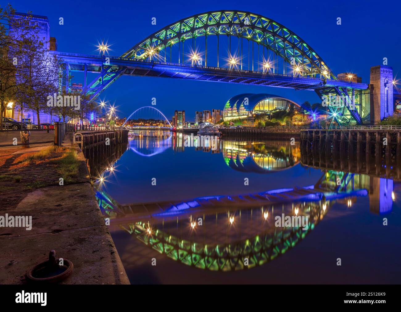 Dusk view of The Tyne Bridge floodlit and reflected in the River Tyne ...