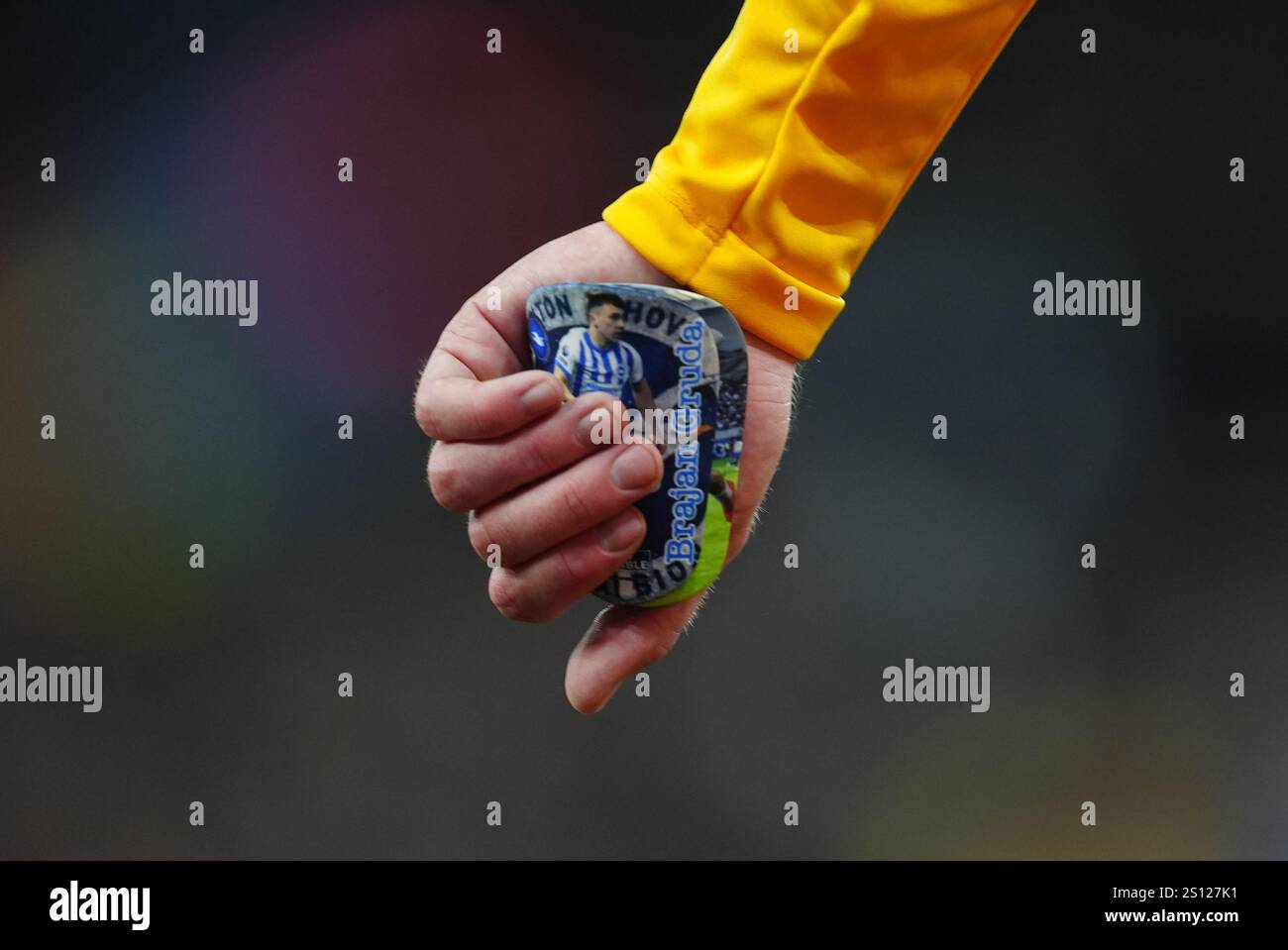 Brighton and Hove Albion's Brajan Gruda holds his shin pad in his hand ...