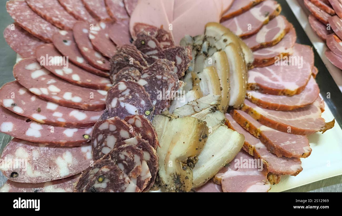 A close-up of the meat platter, showcasing an assortment of sliced ...