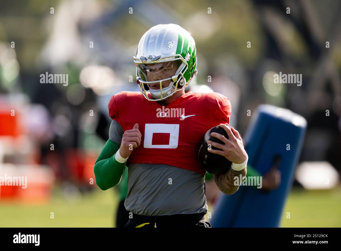 Oregon quarterback Dillon Gabriel runs with the ball during practice in ...