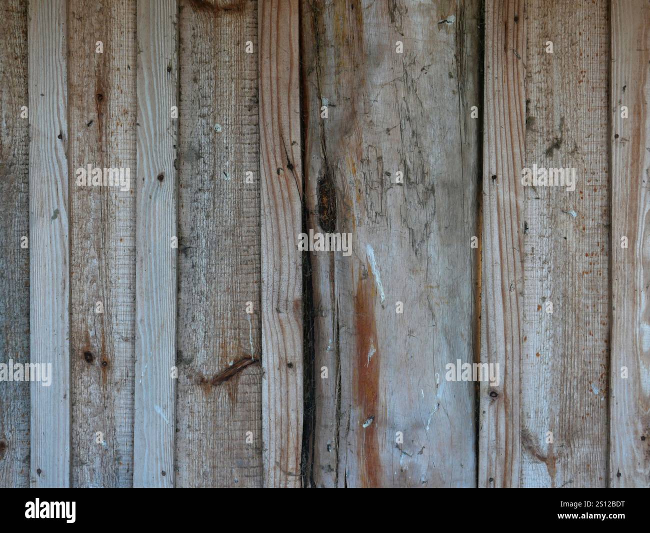 The wooden wall shows planed wood, the surface of which is heavily ...