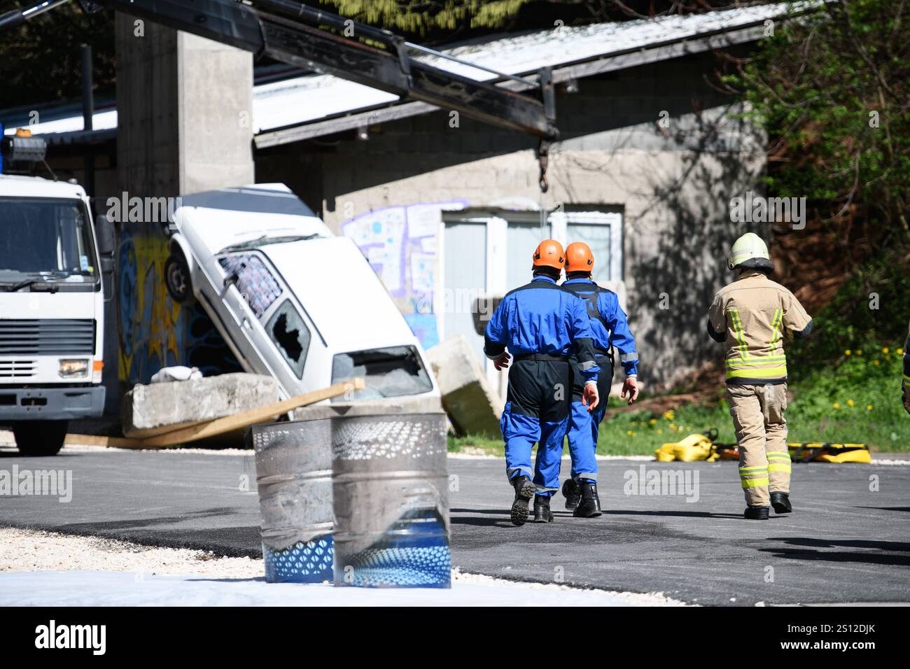 Professional rescuers and firefighters collaborating at accident scene ...