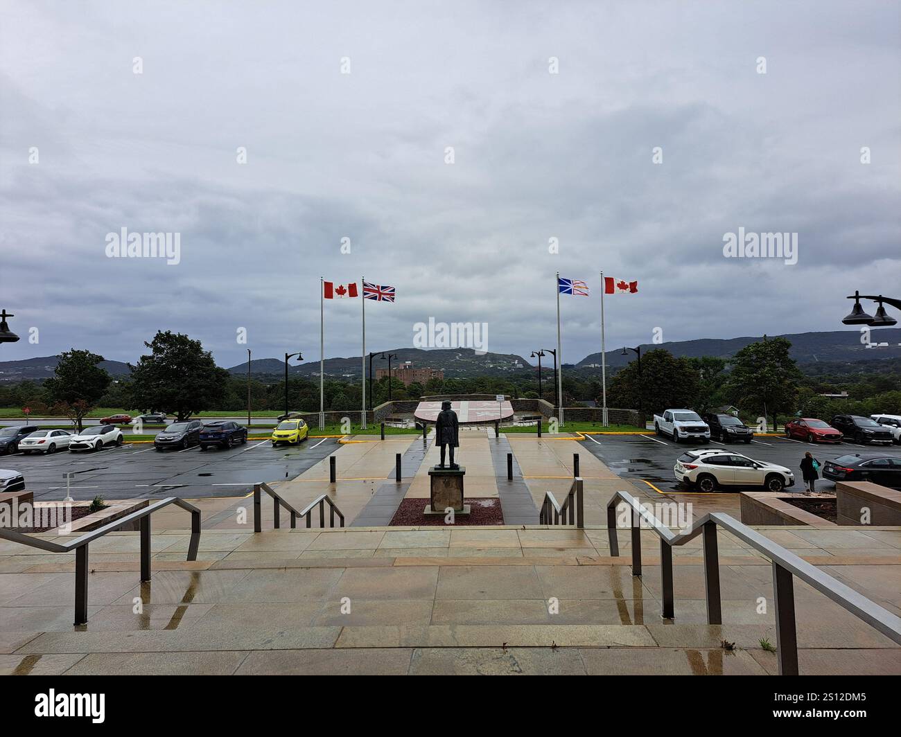 Flags and statue of John Cabot in the parking lot of the provincial ...