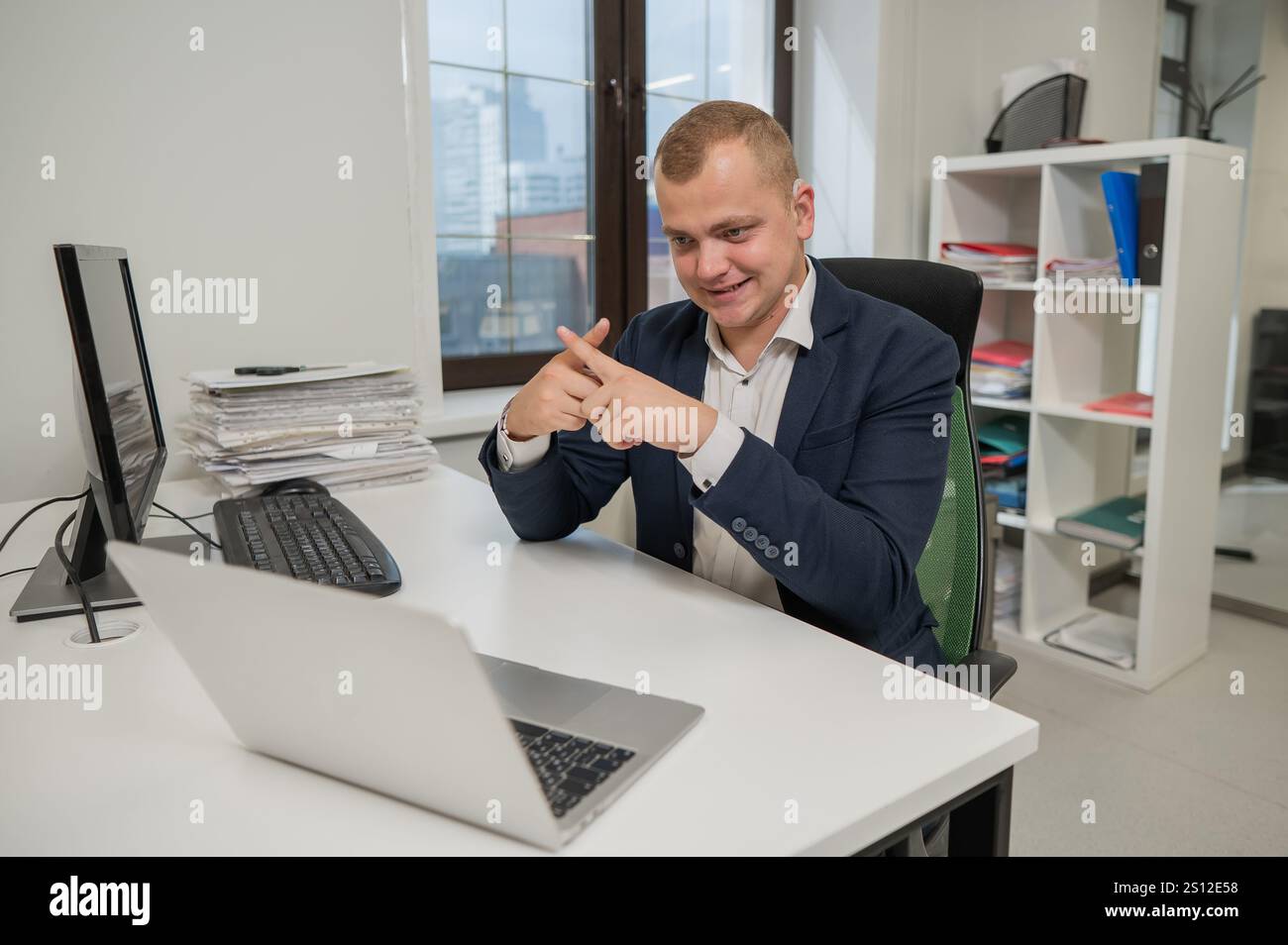 Caucasian deaf man talking sign language over video call on laptop in ...