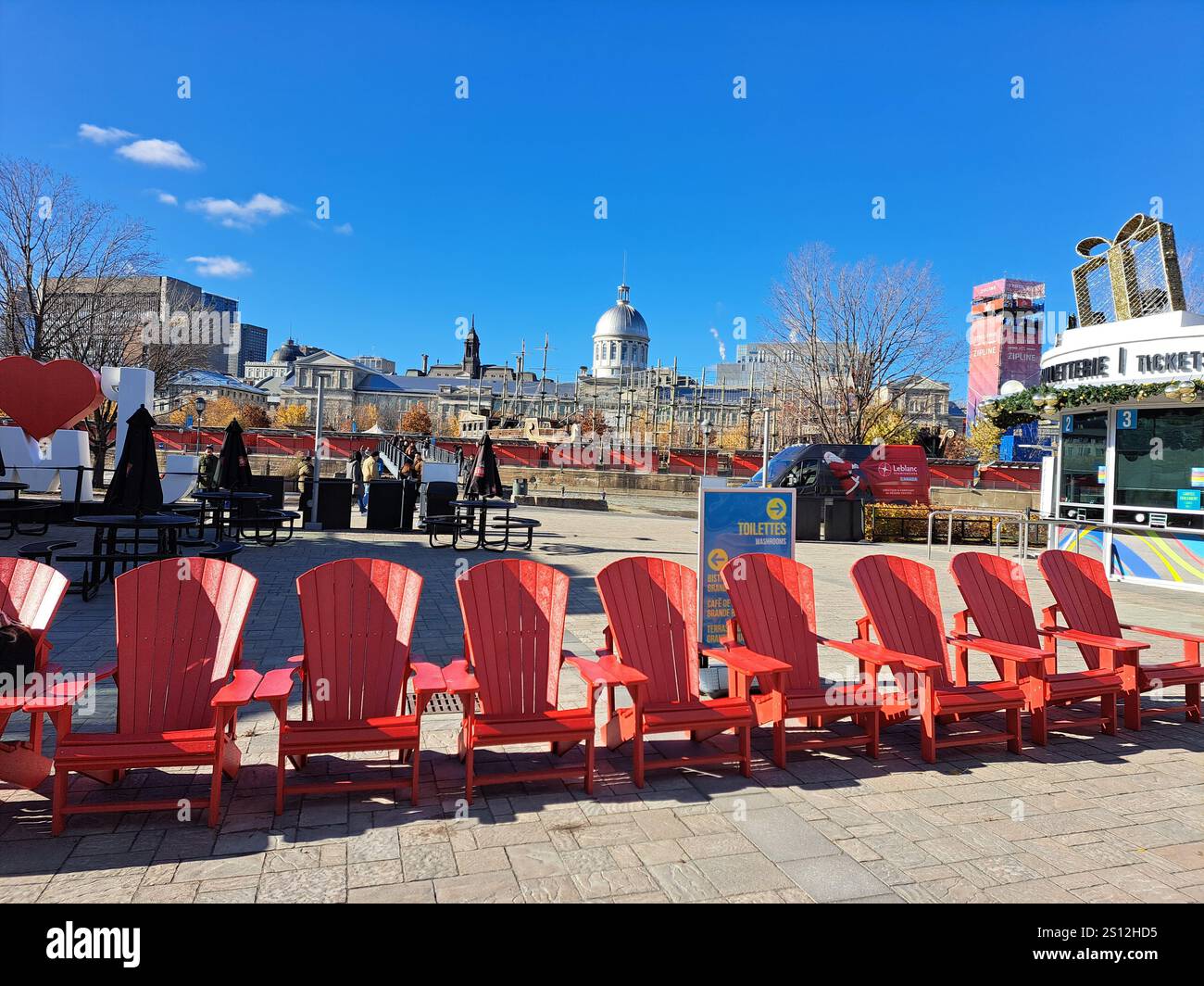 Red Adirondack chairs on the roof top garden patio at the Grand Quay in ...