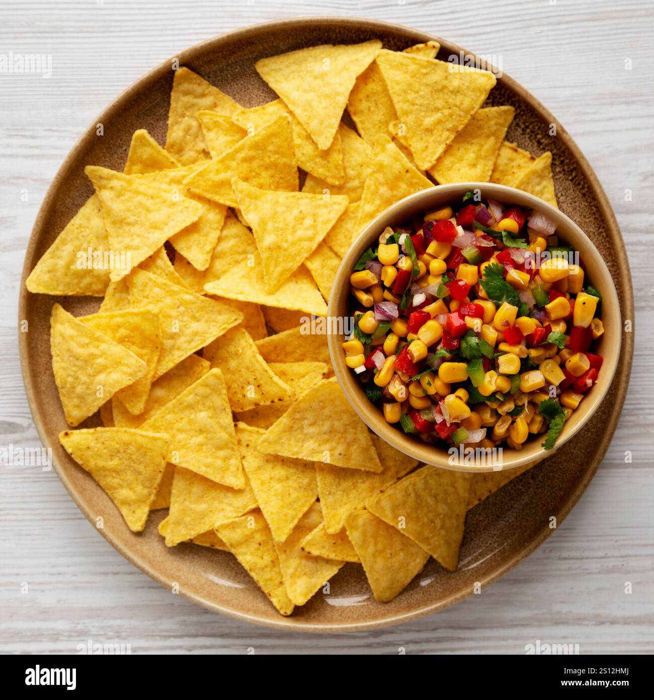 Homemade Corn Salsa with Tortilla Chips on a Plate, top view. Flat lay ...