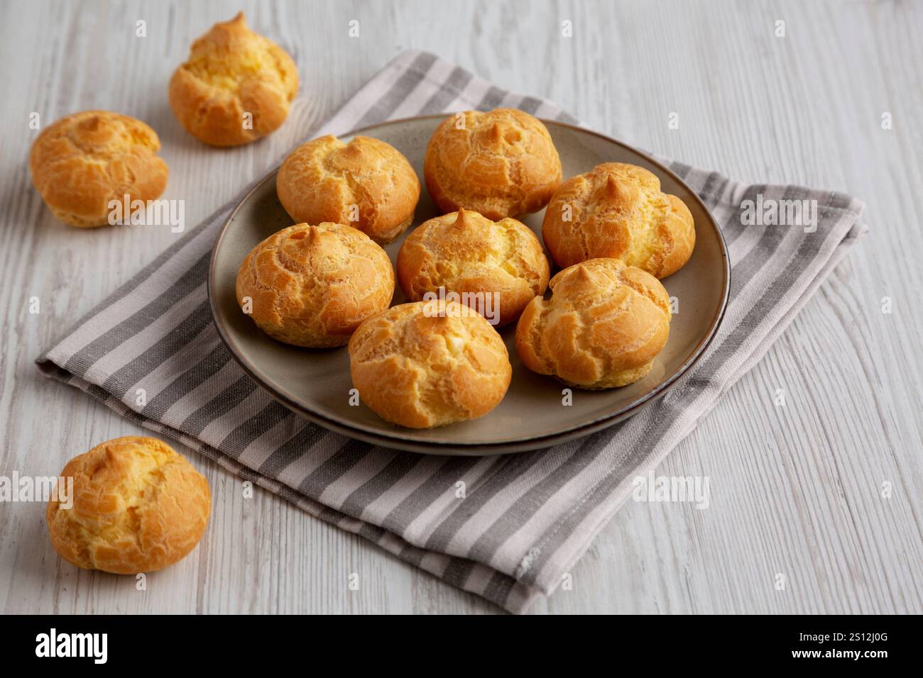 Homemade French Mini Cream Puffs on a Plate, side view Stock Photo - Alamy