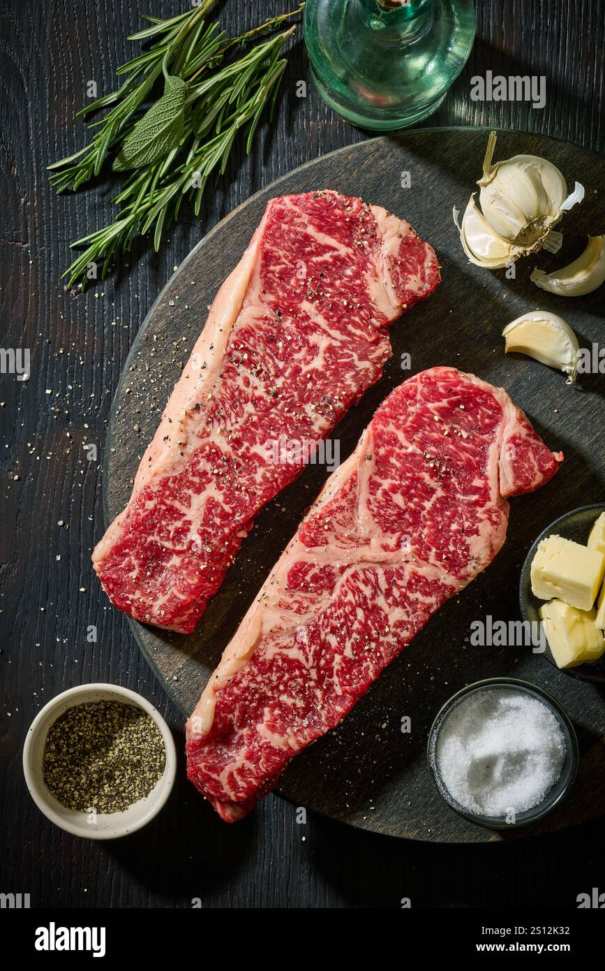 fresh raw Australian Wagyu steak on black wooden kitchen table surface ...