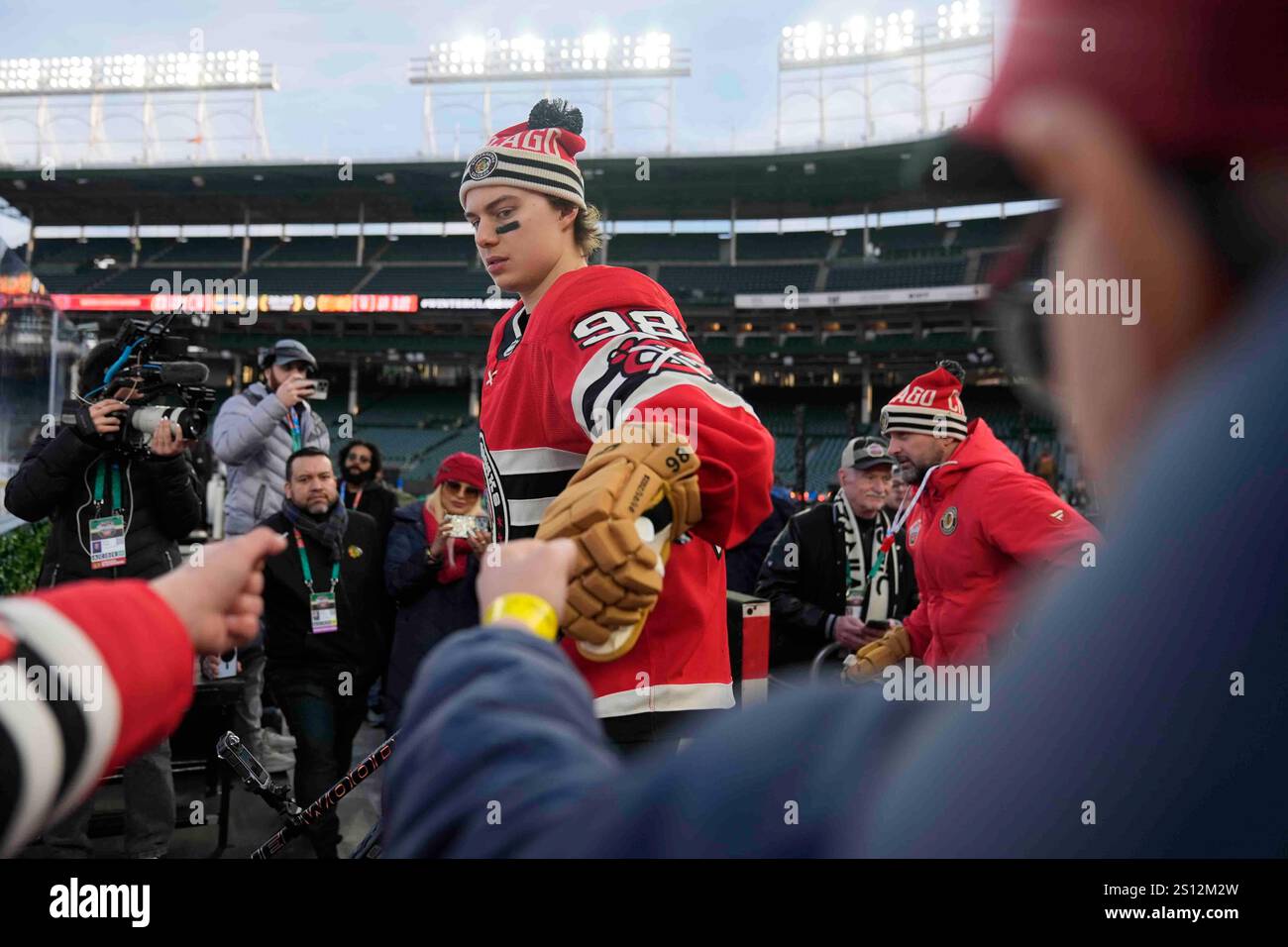 Chicago Blackhawks center Connor Bedard (98) fist-bumps young fans ...