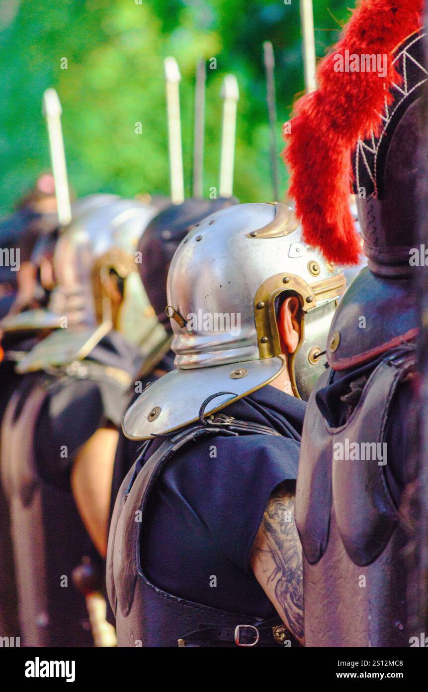 Men equipped as a Roman legionary formed in a row at a historical ...
